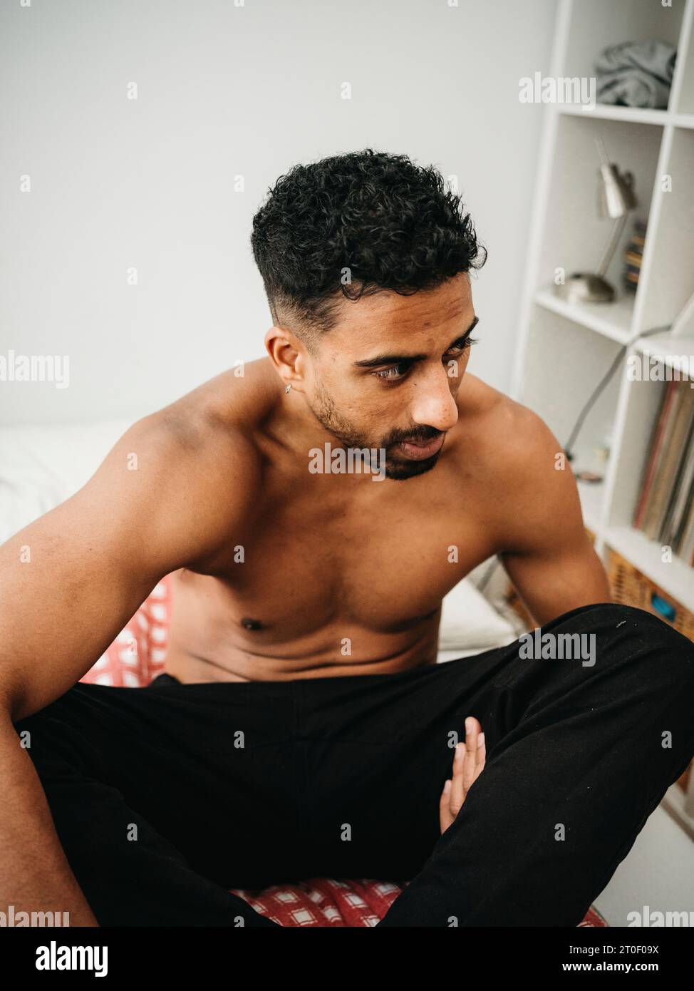 Non-binary person with bare upper body in bed Stock Photo - Alamy