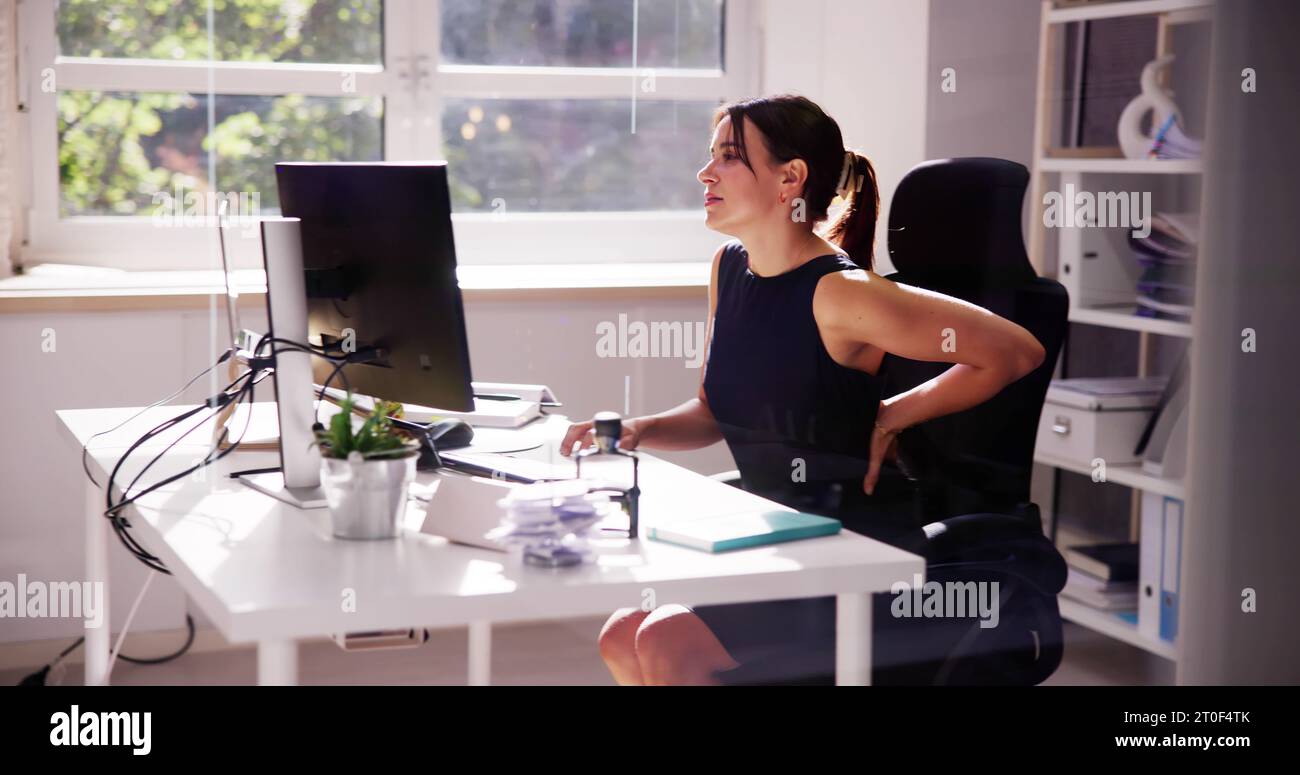 Back Pain Bad Posture Woman Sitting In Office Stock Photo - Alamy