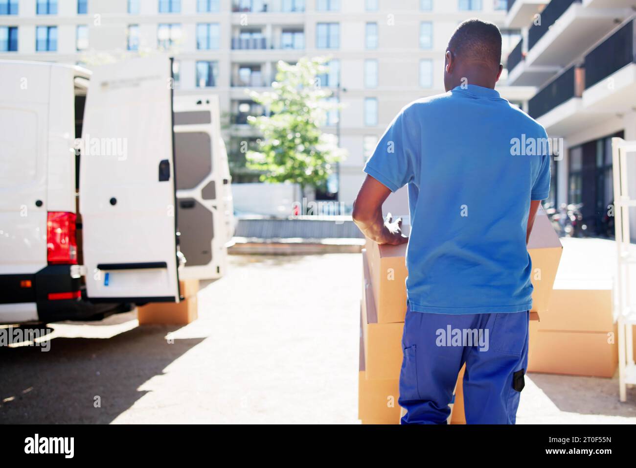 African American Movers. Delivery Boxes On Handtruck Stock Photo - Alamy