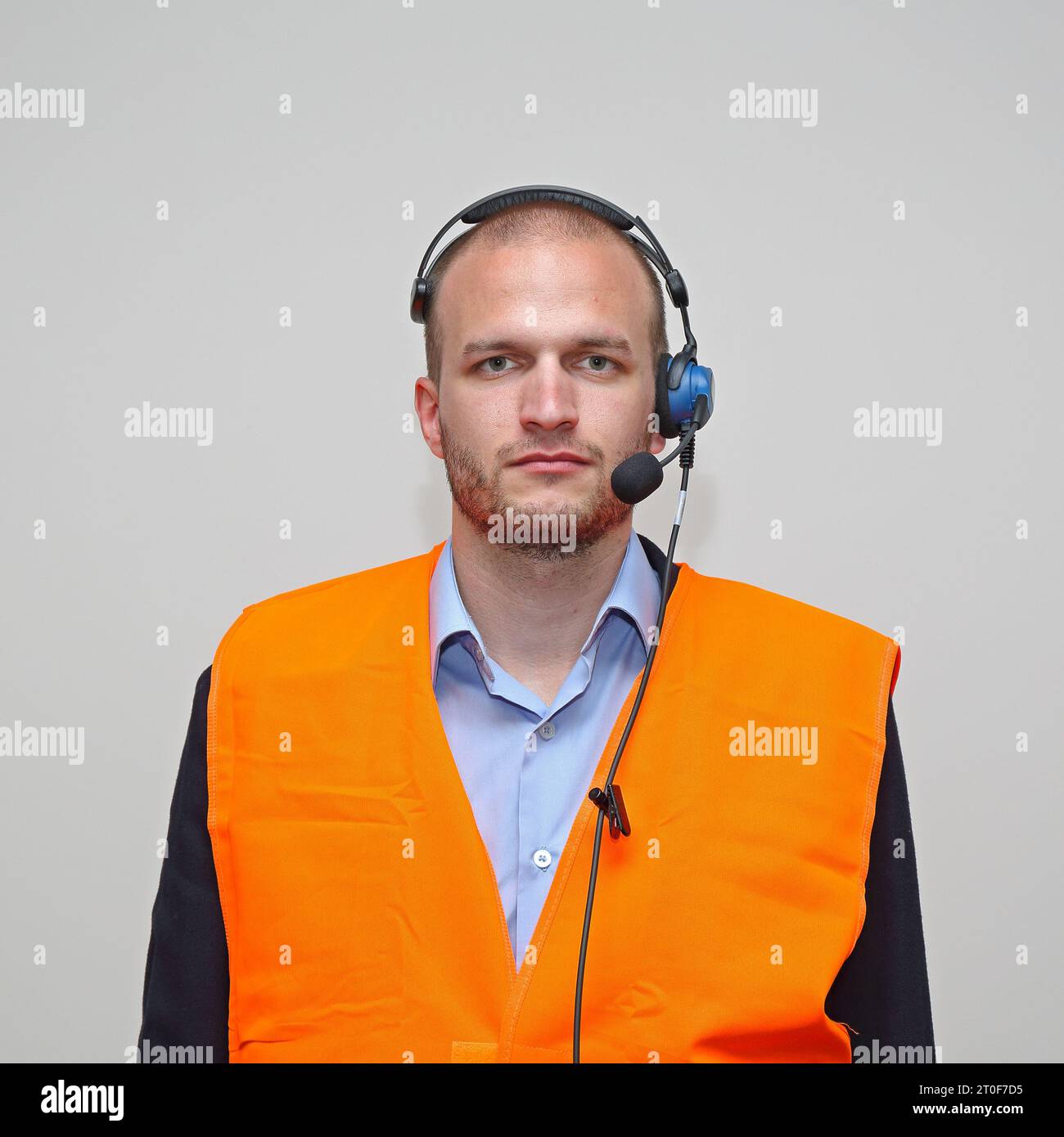 Warehouse Worker With Wired Headset and Orange Safety Vest Stock Photo ...