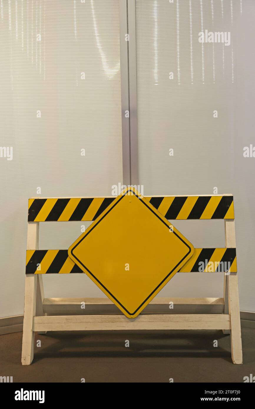 Construction site barrier with yellow warning sign hi-res stock ...