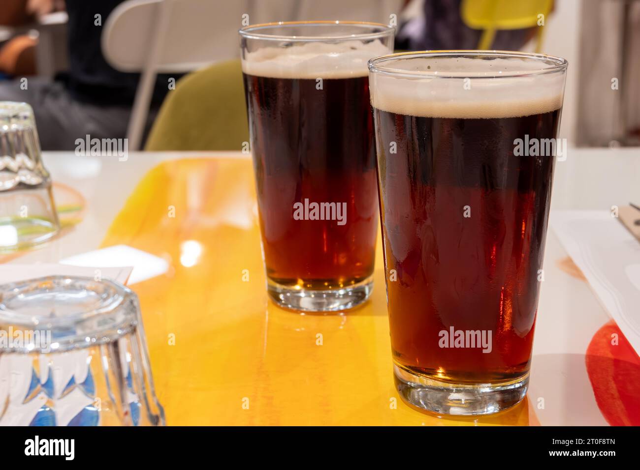 Pint glasses of cold fresh british IPA ale and lager beer served in old ...