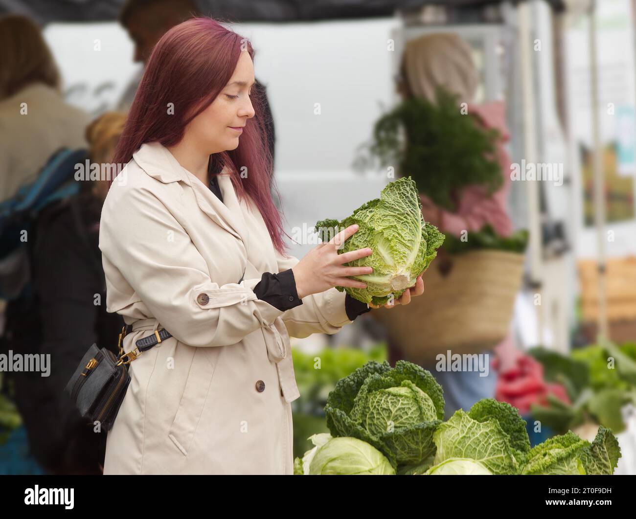 Pretty young woman buying vegetables at a farmers street food market in ...
