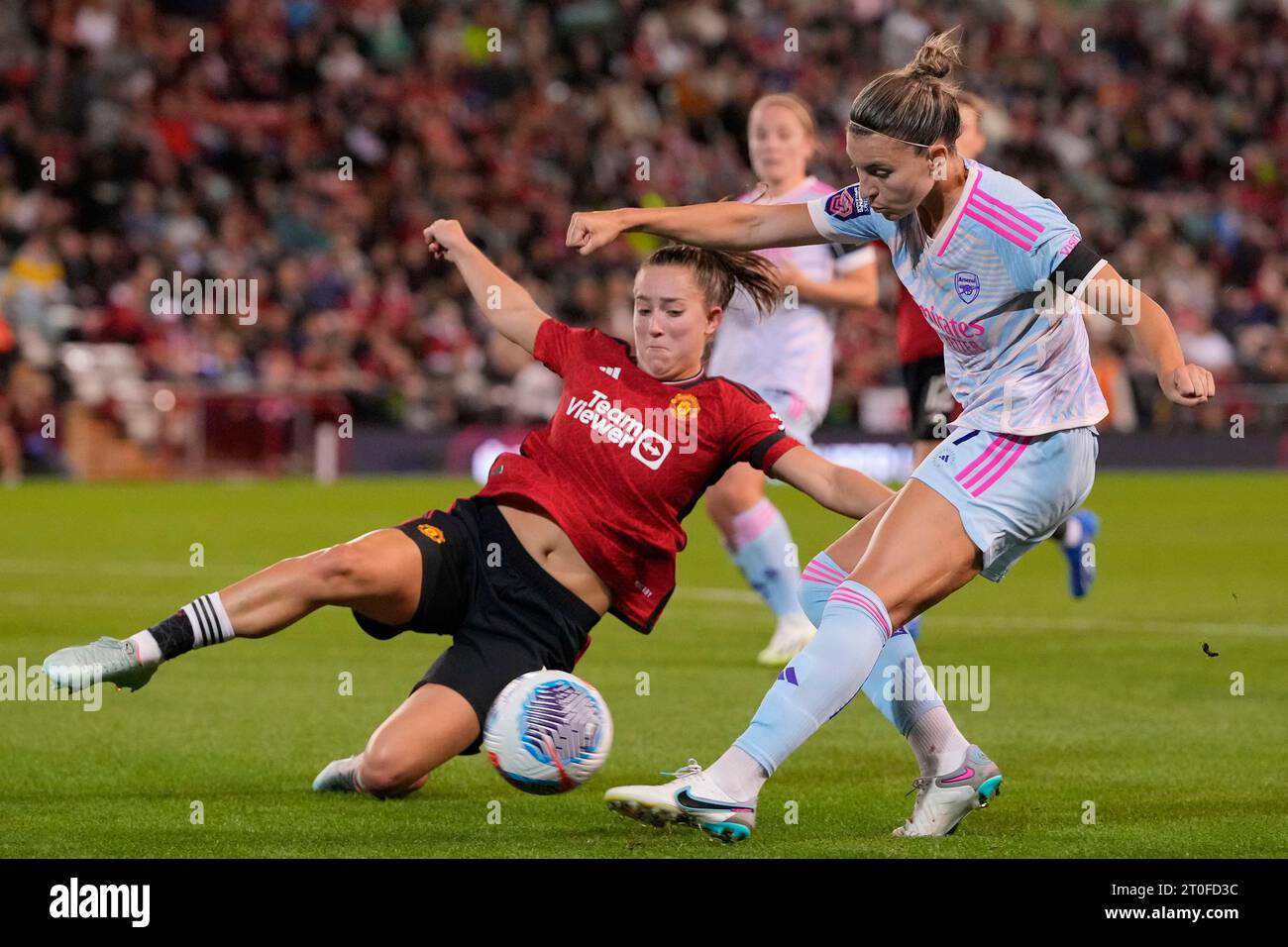Steph Catley #7 of Arsenal Women crosses the ball under pressure from ...