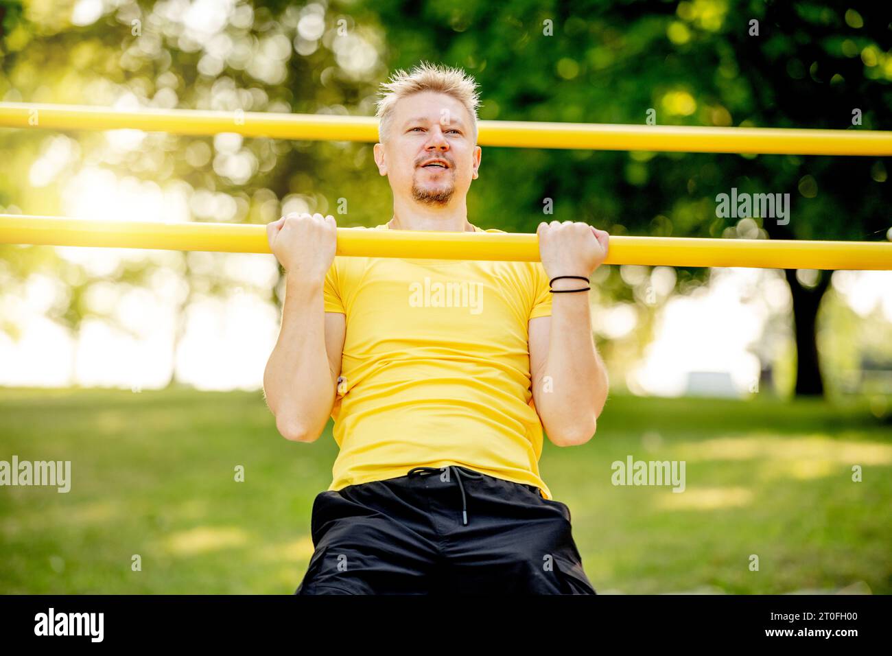 Guy doing pull ups in park hi-res stock photography and images - Alamy