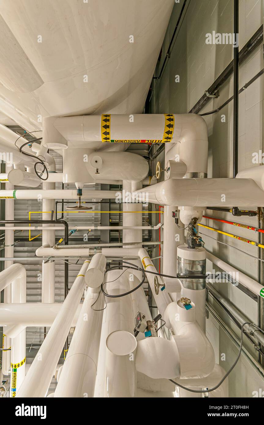 White piping and insulation along wall inside a cold-storage ...