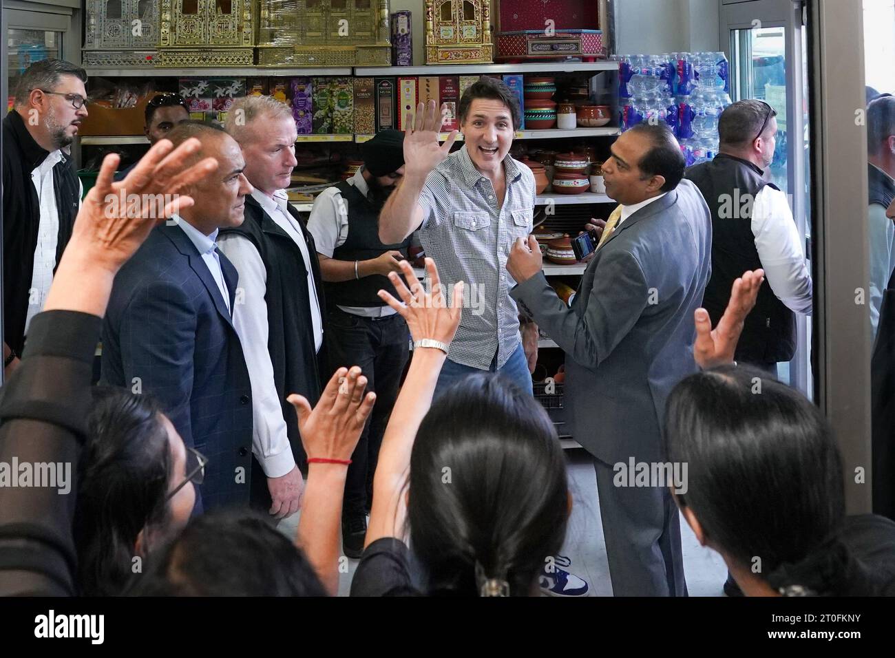 Prime Minister Justin Trudeau waves to employees following a visit Desi ...