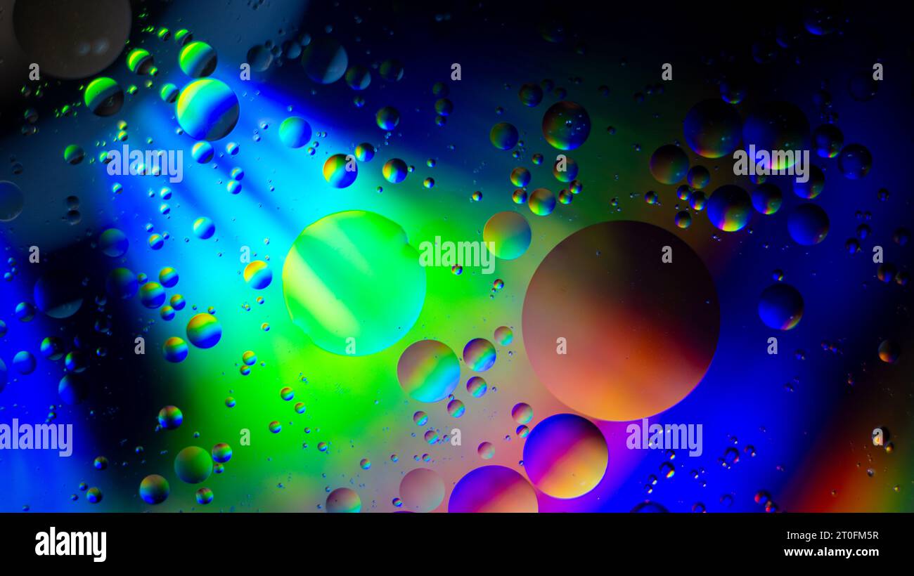 Mix of oil and water forming patches of oil rings and discs over a ...