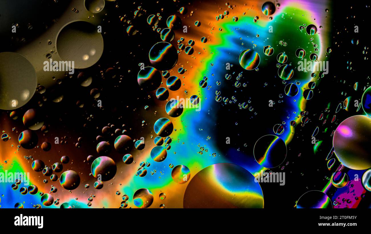 Mix of oil and water forming patches of oil rings and discs over a ...