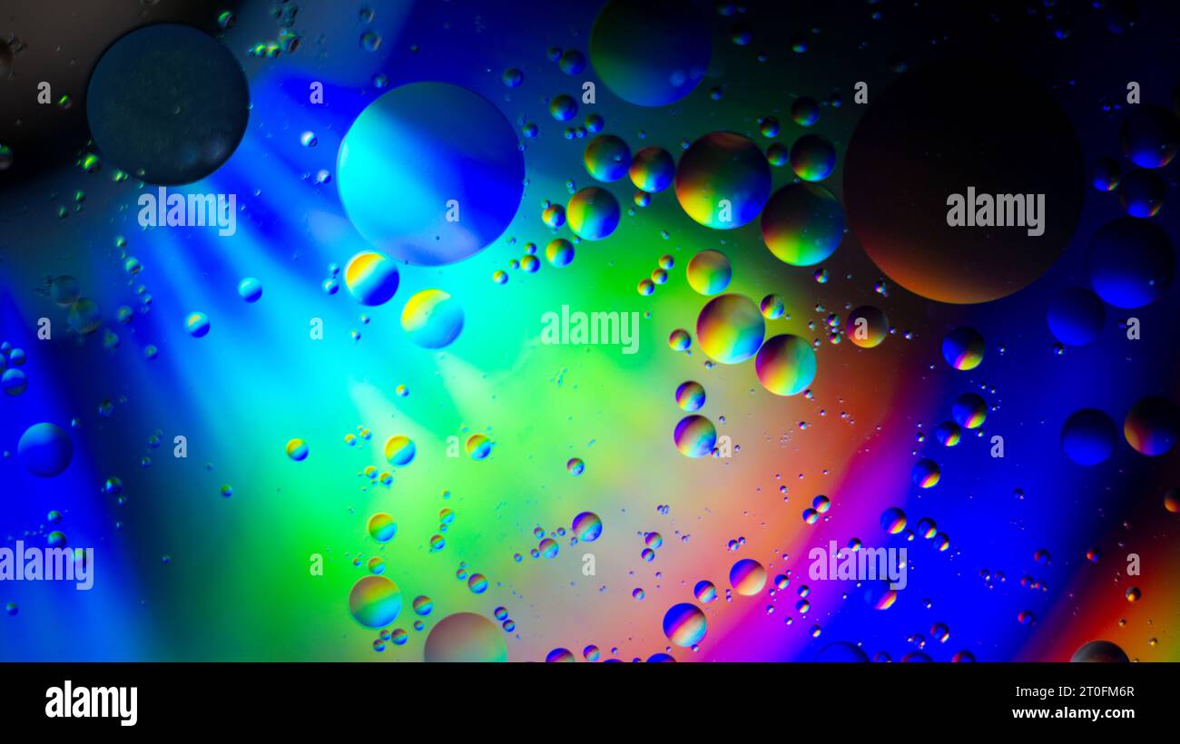 Mix of oil and water forming patches of oil rings and discs over a ...