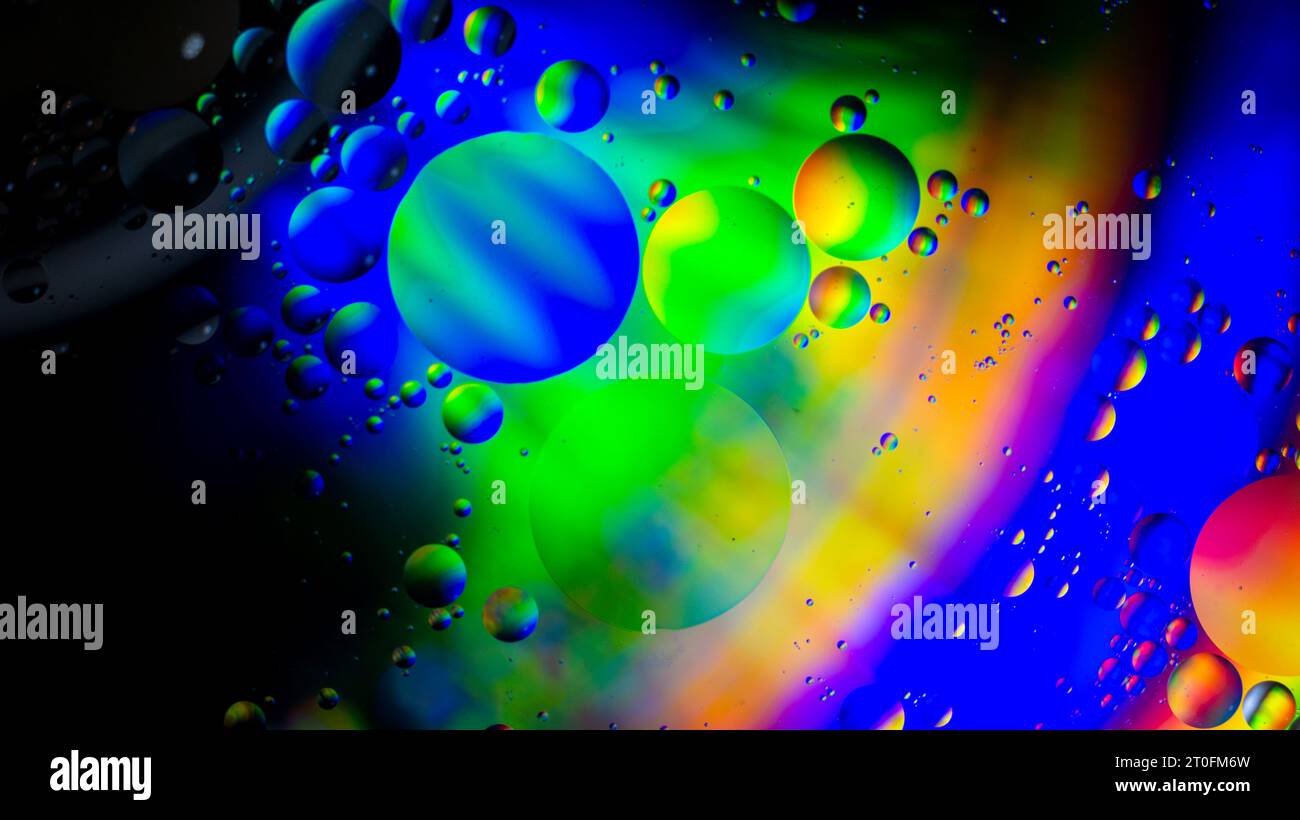 Mix of oil and water forming patches of oil rings and discs over a ...