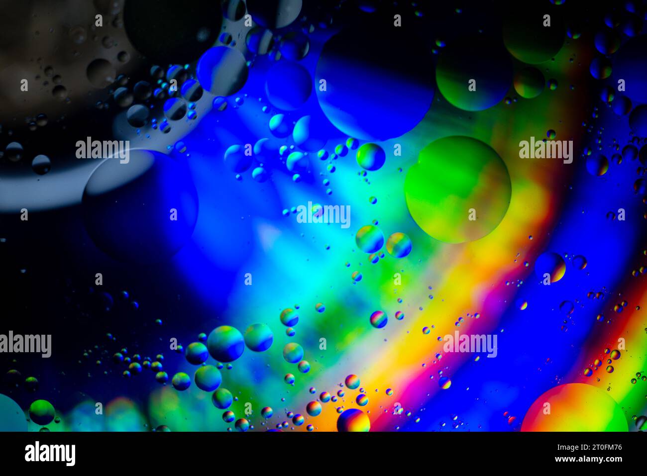 Mix of oil and water forming patches of oil rings and discs over a ...