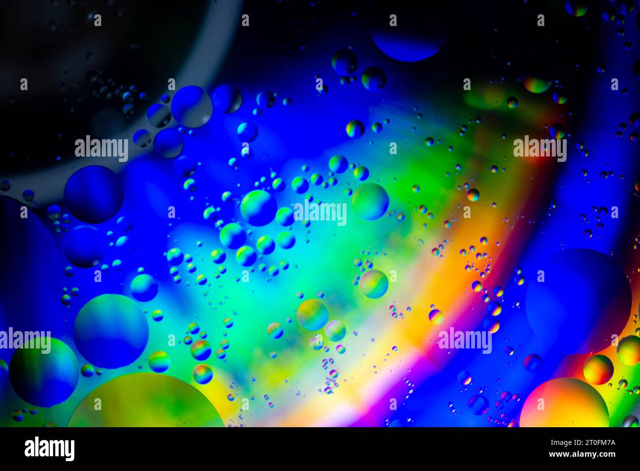 Mix of oil and water forming patches of oil rings and discs over a ...