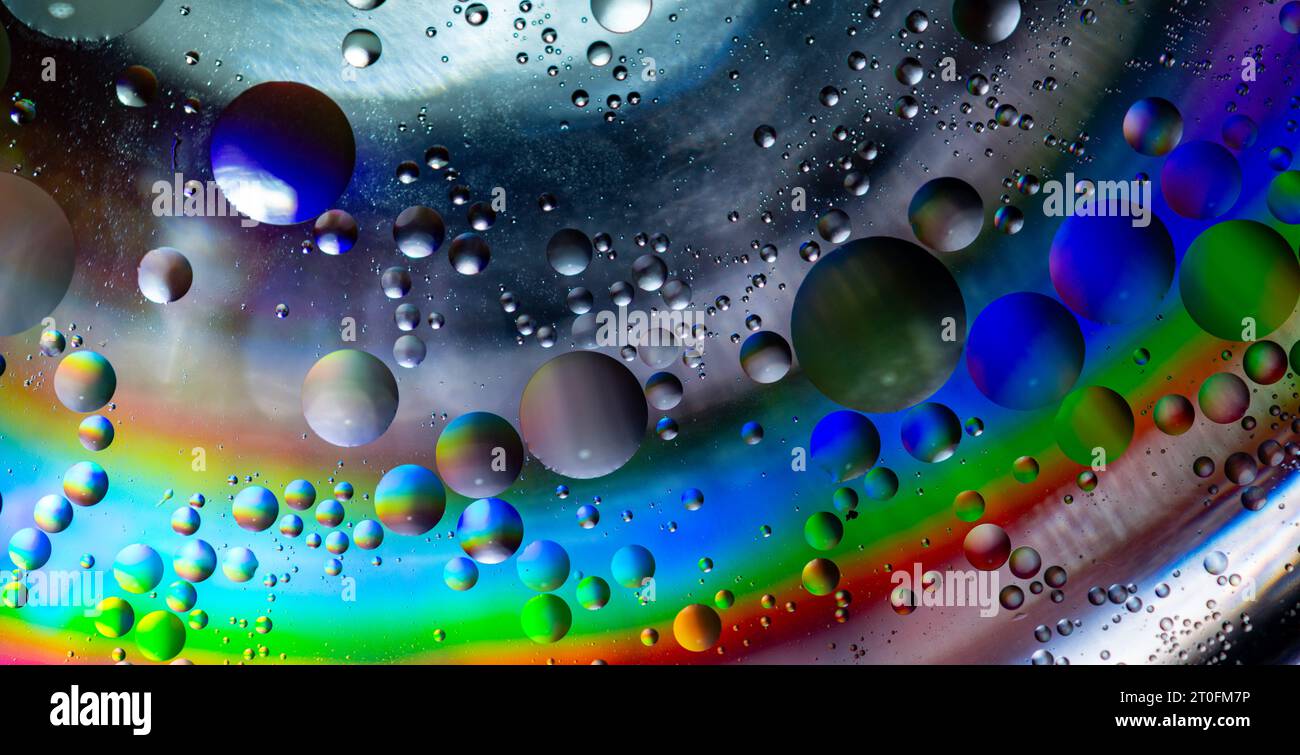 Mix of oil and water forming patches of oil rings and discs over a ...