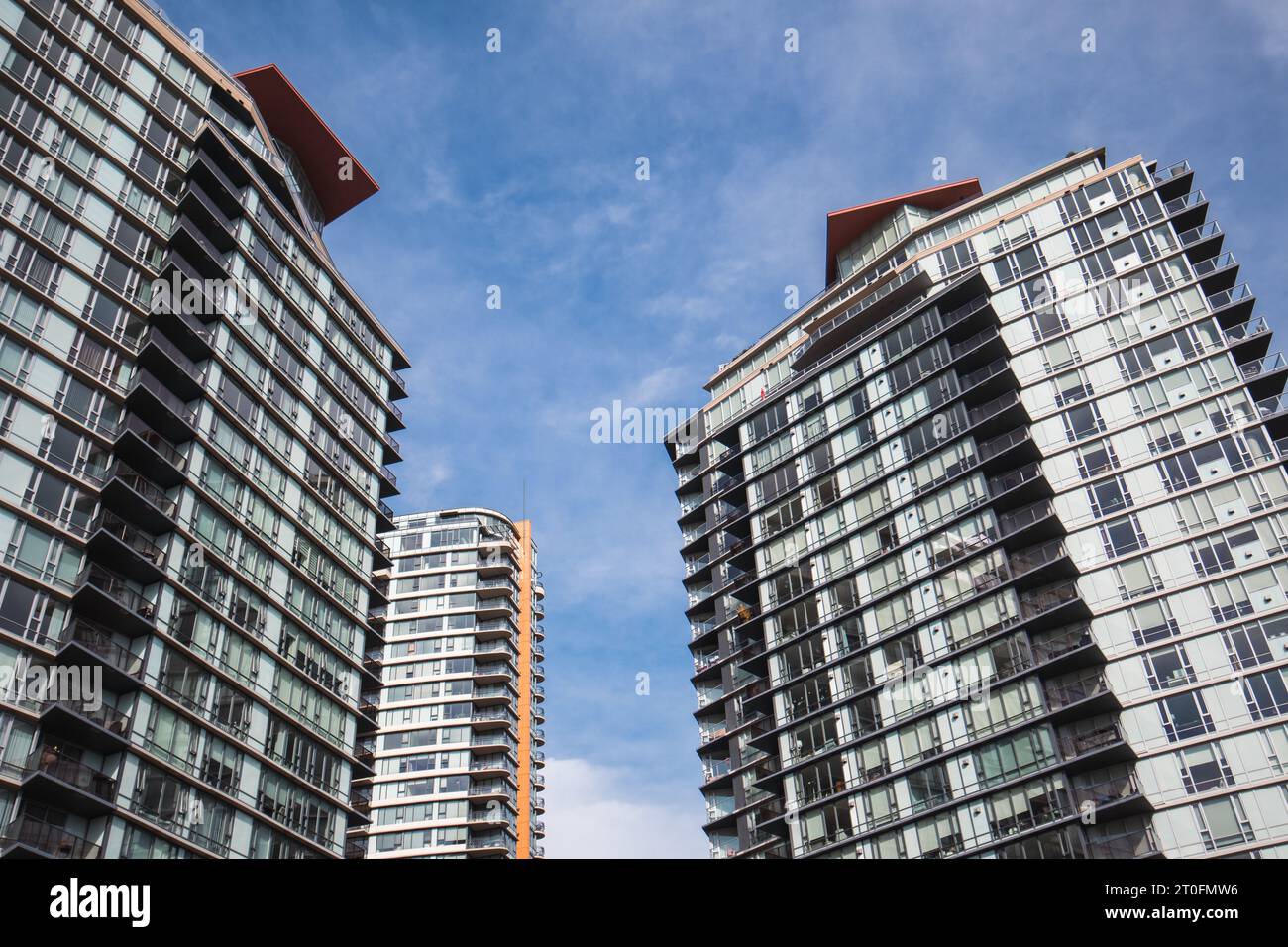 Modern highrise building or tall residential towers with blue sky ...