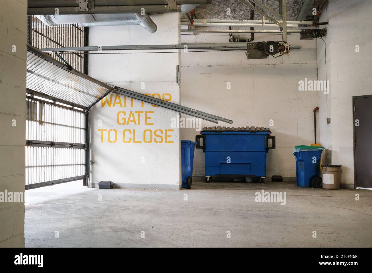 Parking gate damaged in parkade of building. Garage exit of strata ...