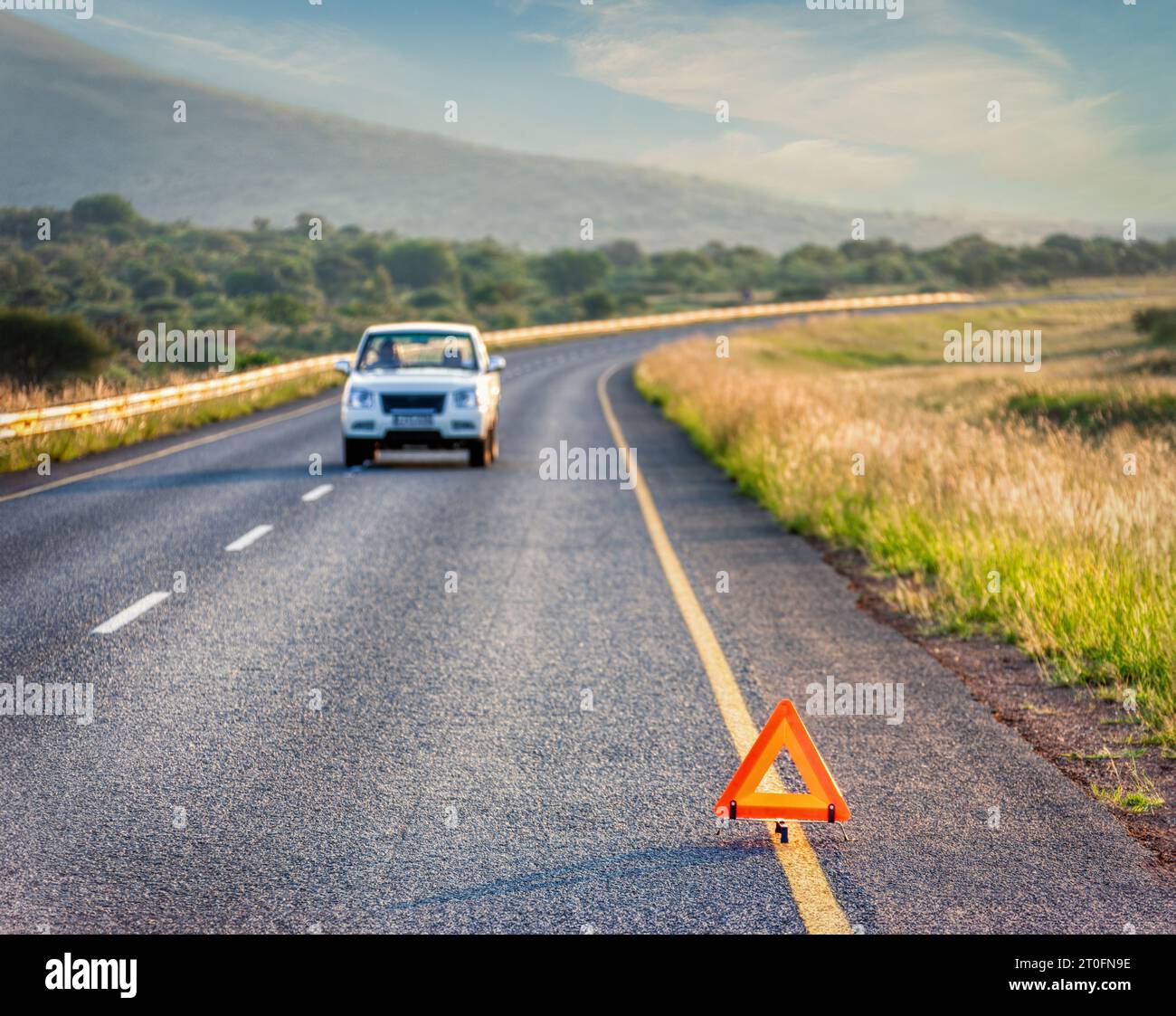 red reflective triangle sign, asking for help on the side of the road ...