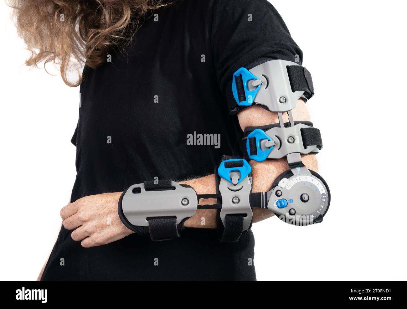 Woman with elbow brace or postoperative ROM brace. Medical device used ...