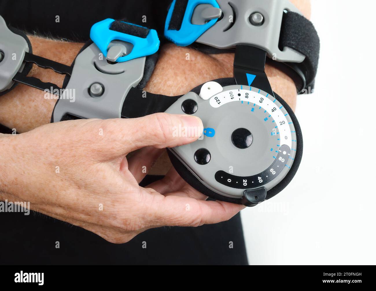 Woman with elbow brace or postoperative ROM brace. A person adjusting ...