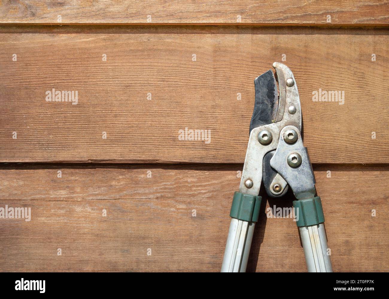 Garden lopper on wood background. Gardening tool texture. Well used ...