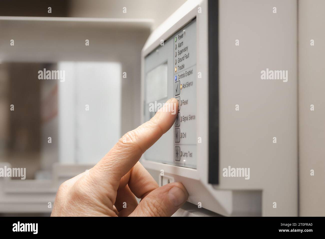 Fire alarm technician using the fire alarm control panel or annunciator ...