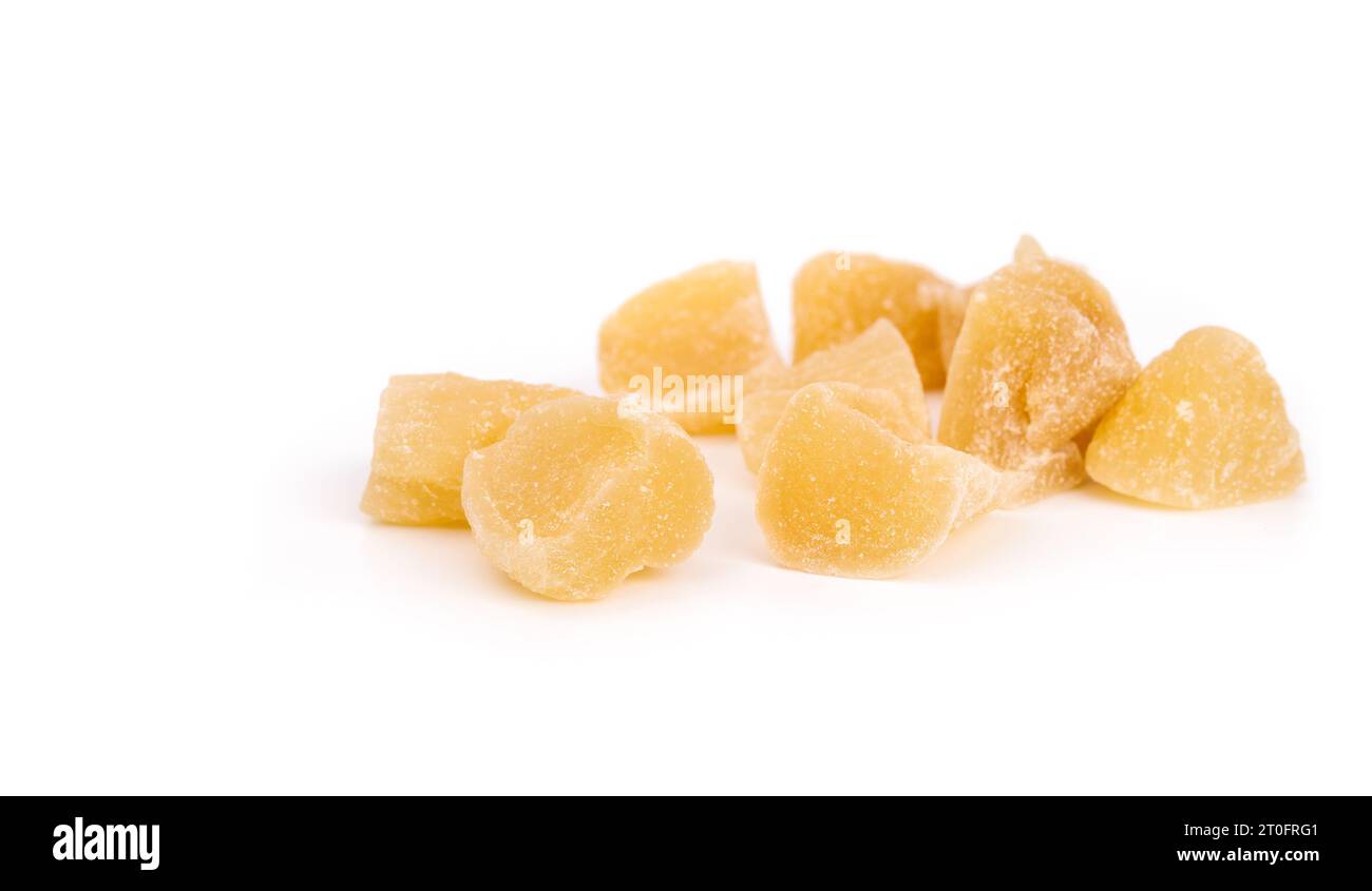 Candied ginger pieces in random pile. Many yellow chunks of candied or ...