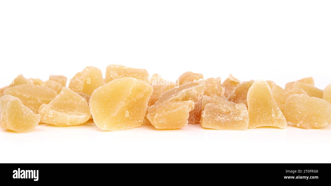 Candied ginger pieces in a row. Many yellow chunks of candied or ...