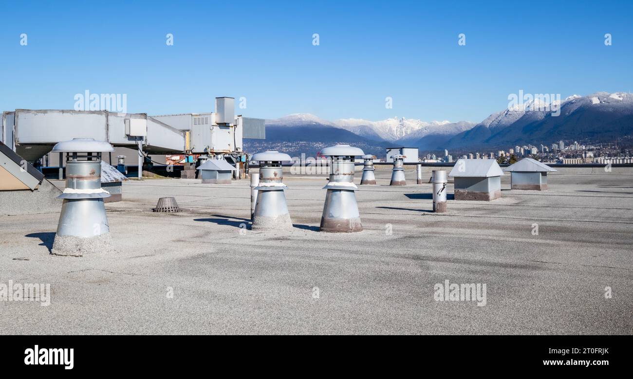 Flat roof vents with hvac unit on building with modified bitumen ...