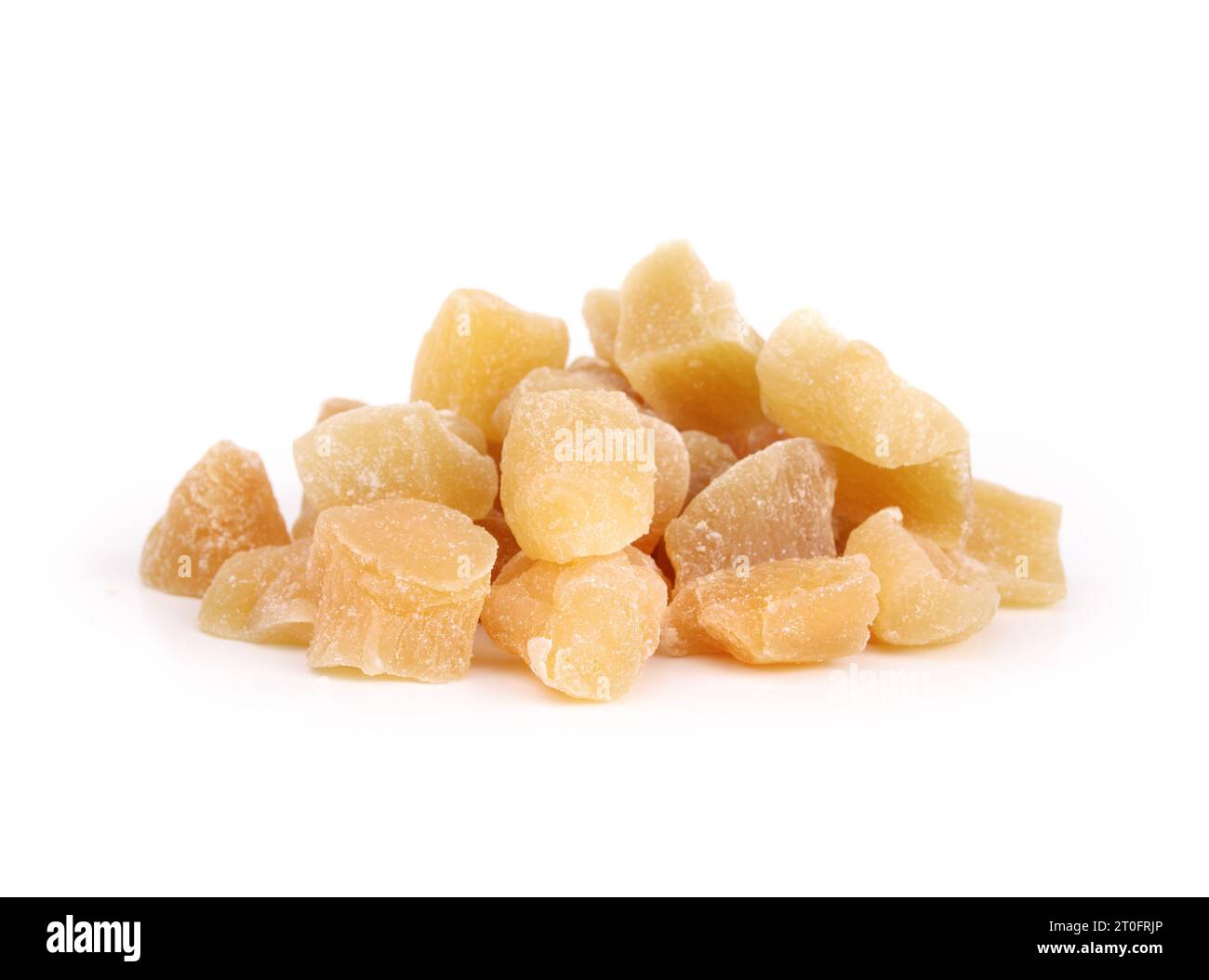 Isolated candied ginger pieces in a pile. Many yellow chunks of candied ...