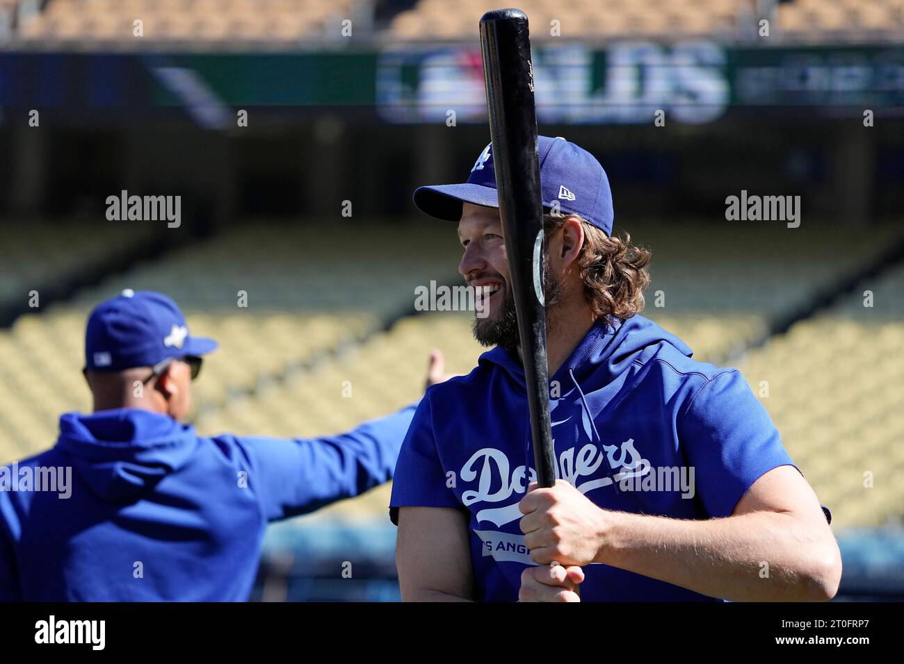 Los Angeles Dodgers starting pitcher Clayton Kershaw, right, warms up ...