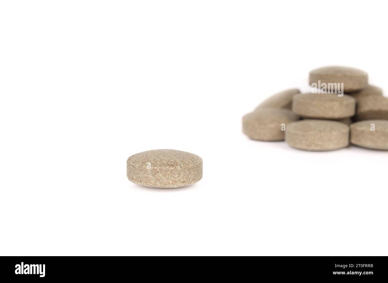 Round wafer tablet with defocused pile. Multiple green textured pressed ...