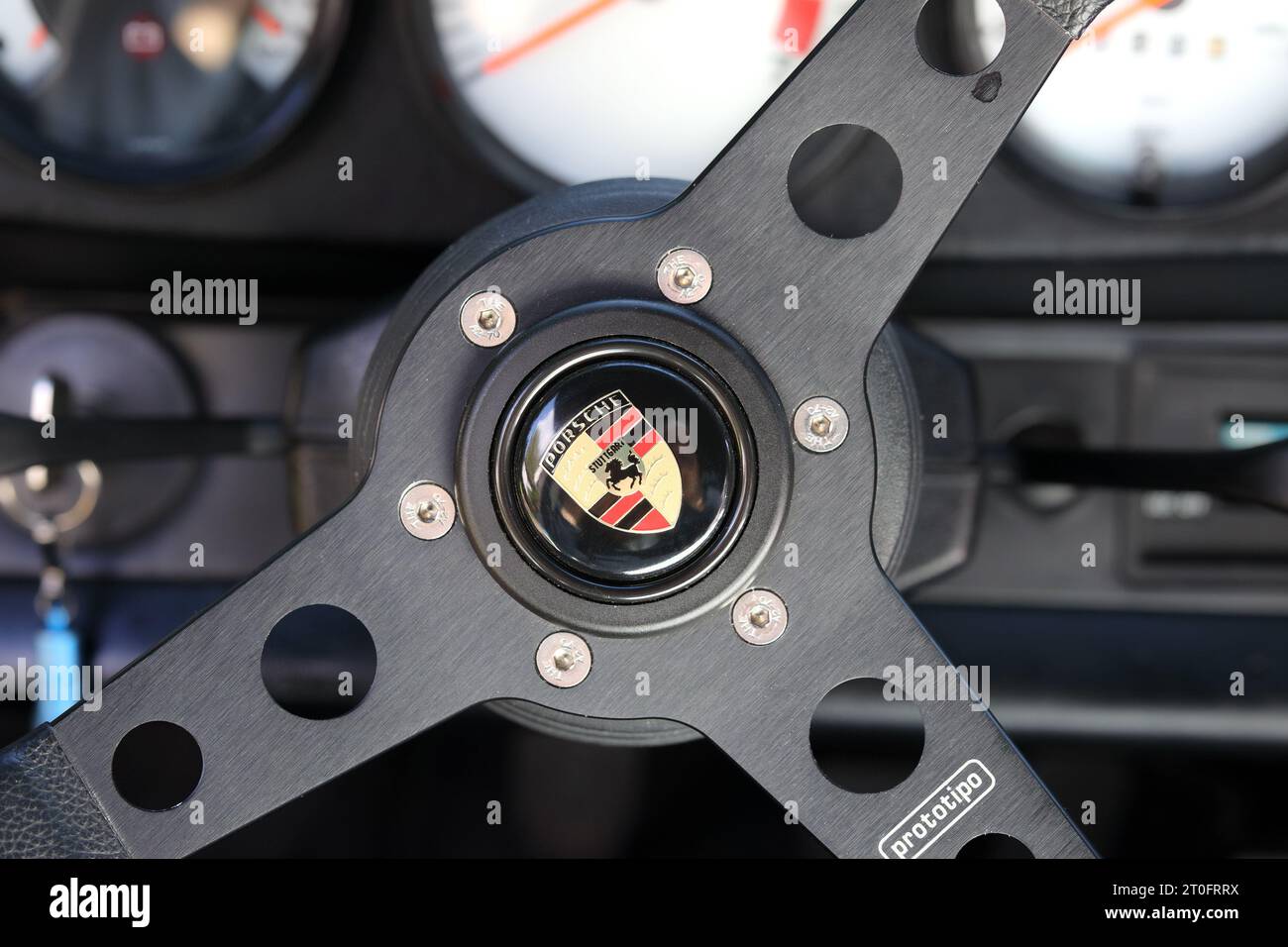 Vintage Porsche emblem logo on 911 SC steering wheel with defocused ...
