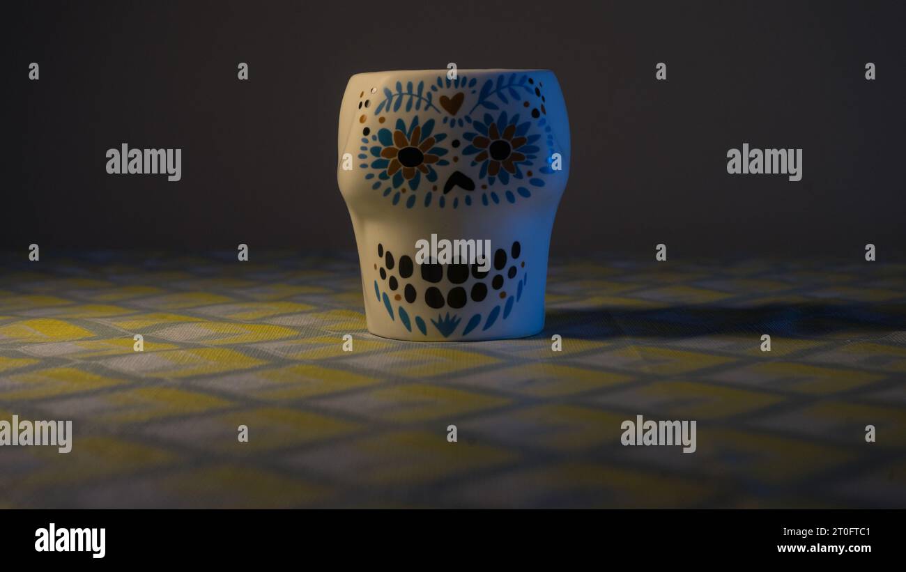 A skull-faced mug makes a bold statement against a mysterious grey ...