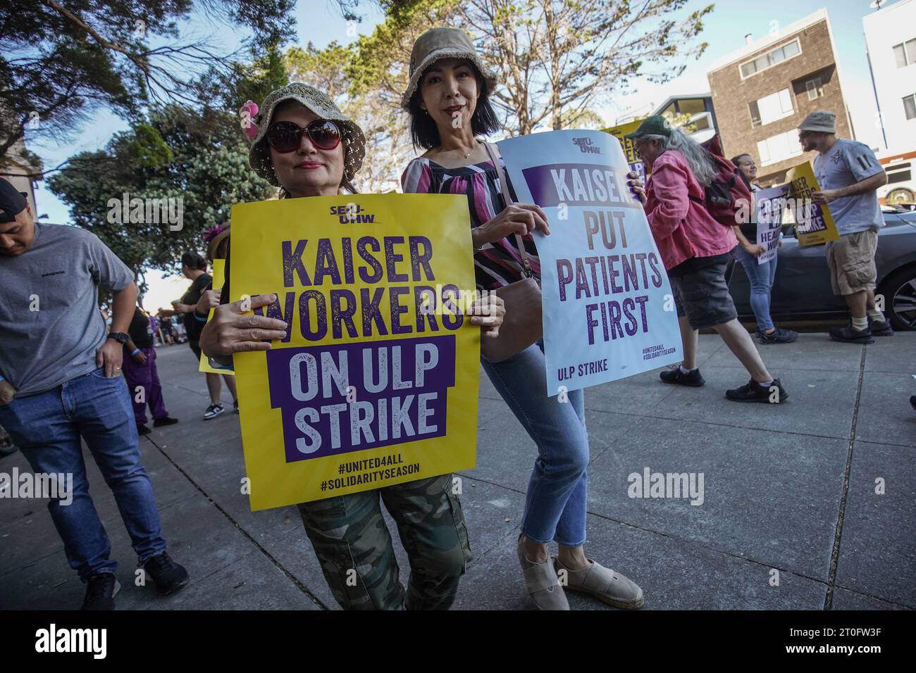 Kaiser Permanente workers hold placards expressing their opinion during ...