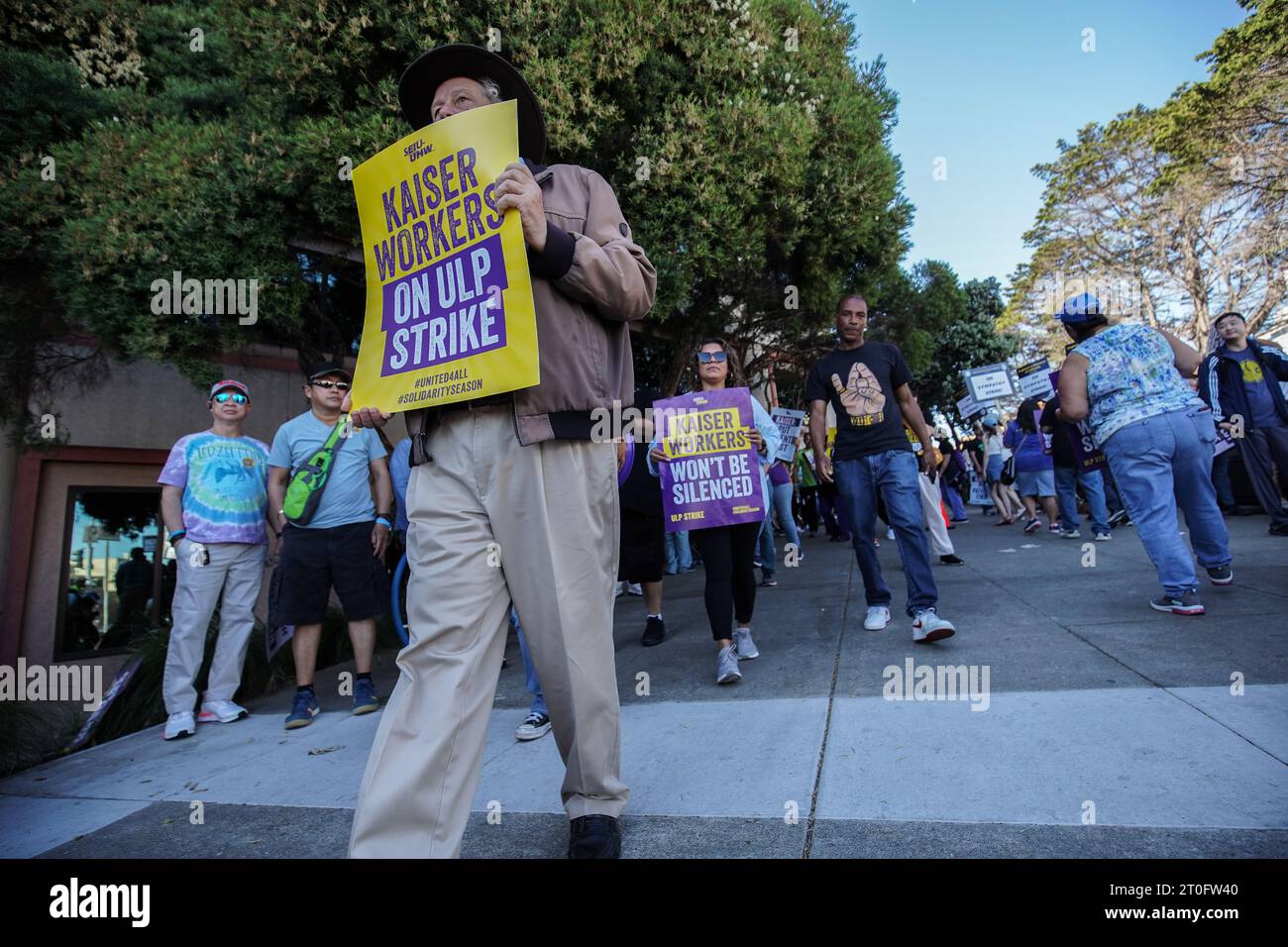 Kaiser Permanente workers hold placards expressing their opinion during ...