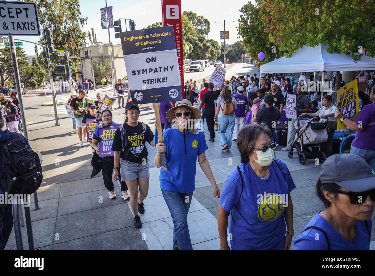 Kaiser Permanente workers hold placards expressing their opinion during ...