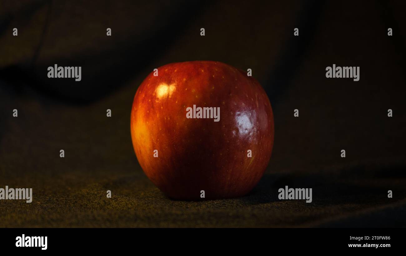 A crisp apple, a symbol of good health and wellness, set against a grey ...