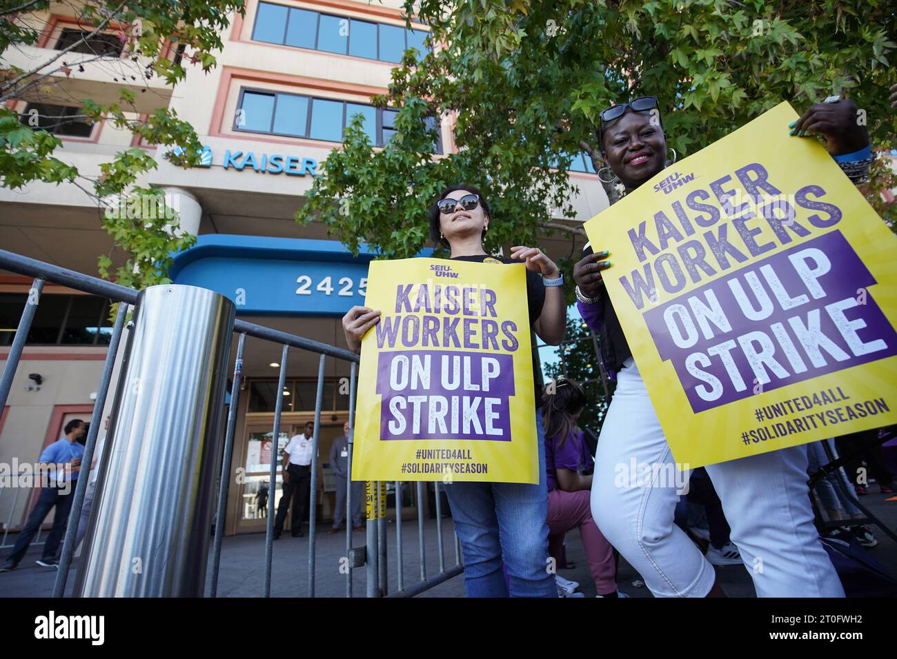 Kaiser Permanente workers hold placards expressing their opinion during ...