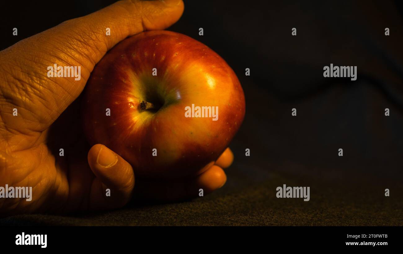 A crisp apple, a symbol of good health and wellness, set against a grey ...