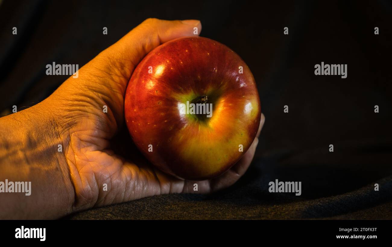 A crisp apple, a symbol of good health and wellness, set against a grey ...