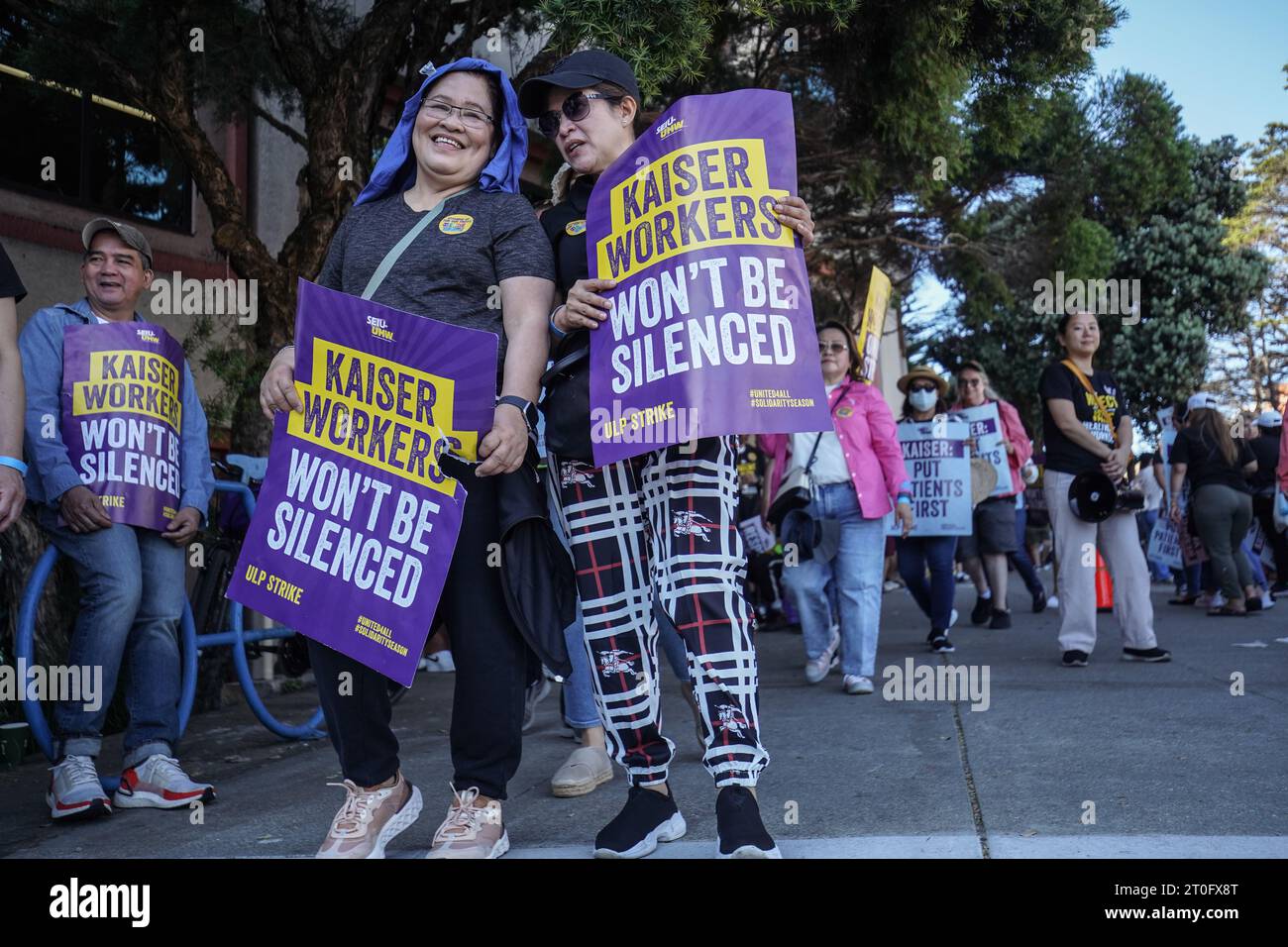 Kaiser Permanente workers hold placards expressing their opinion during ...