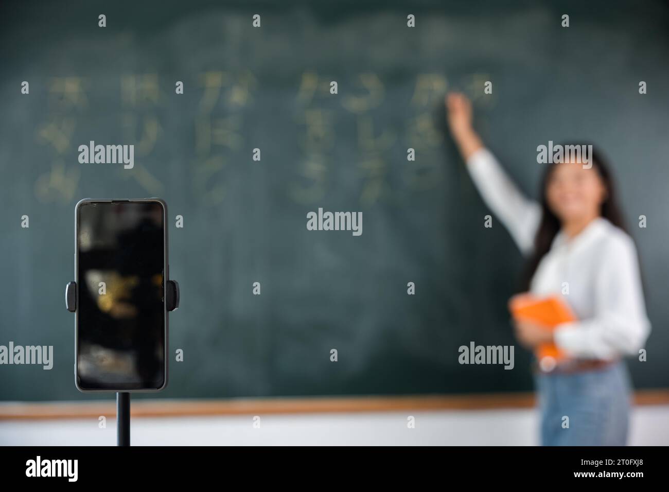 Asian teacher teach on board while have blackboard lecture online ...