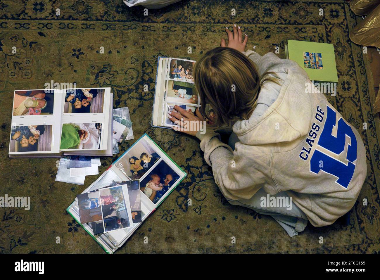 15-year-old Ksiusha Mukhovata shows pictures of her family in the ...