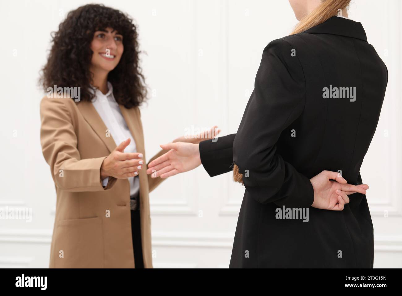 Crossed fingers handshake hi-res stock photography and images - Alamy