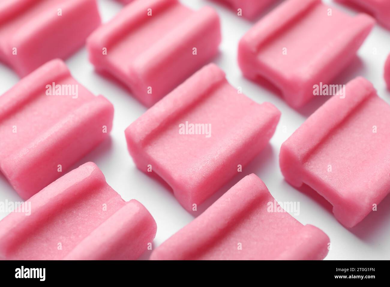 Tasty pink chewing gums on white background, closeup Stock Photo - Alamy