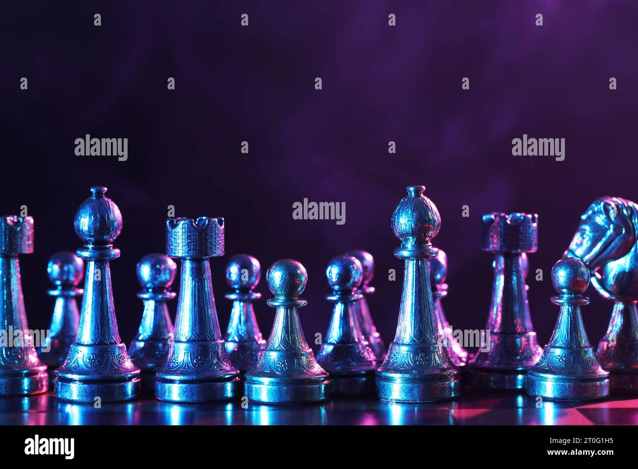 Chess pieces on checkerboard in color light. Space for text Stock Photo ...