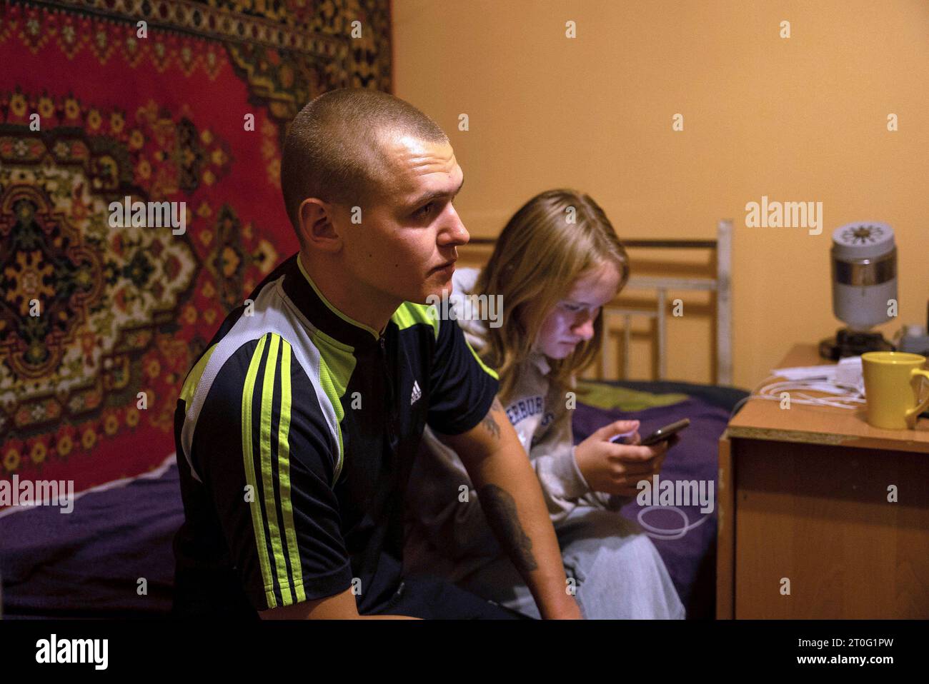 Oleksandr Mukhovatyi, 23, seats on the bed with his sister Ksiusha ...