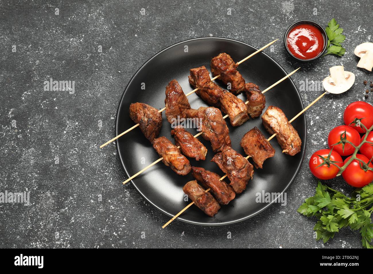 Delicious shish kebabs served on grey textured table, flat lay Stock ...