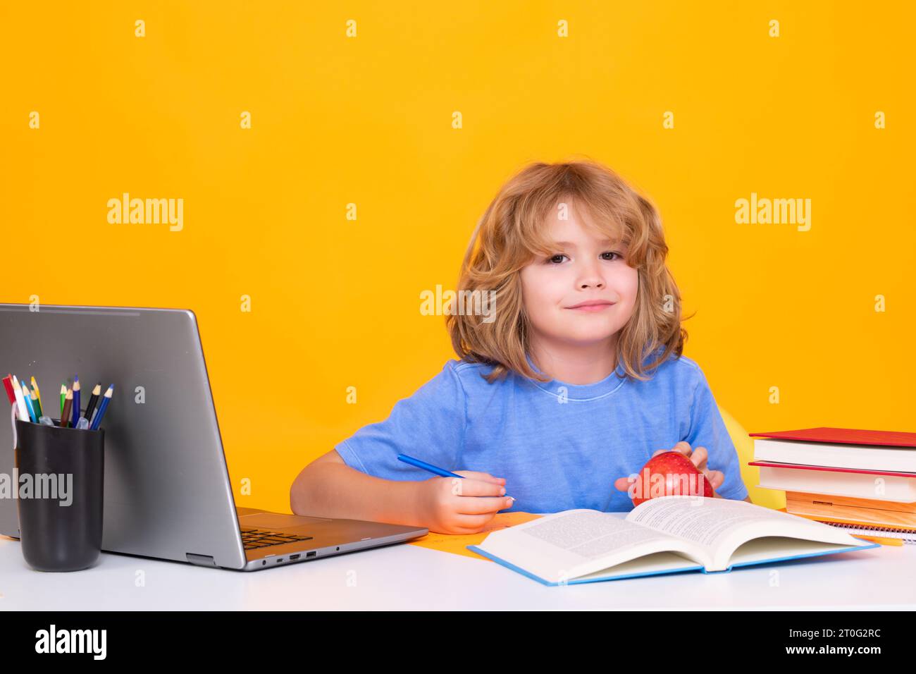 School child using laptop computer. Nerd school kid isolated on studio ...