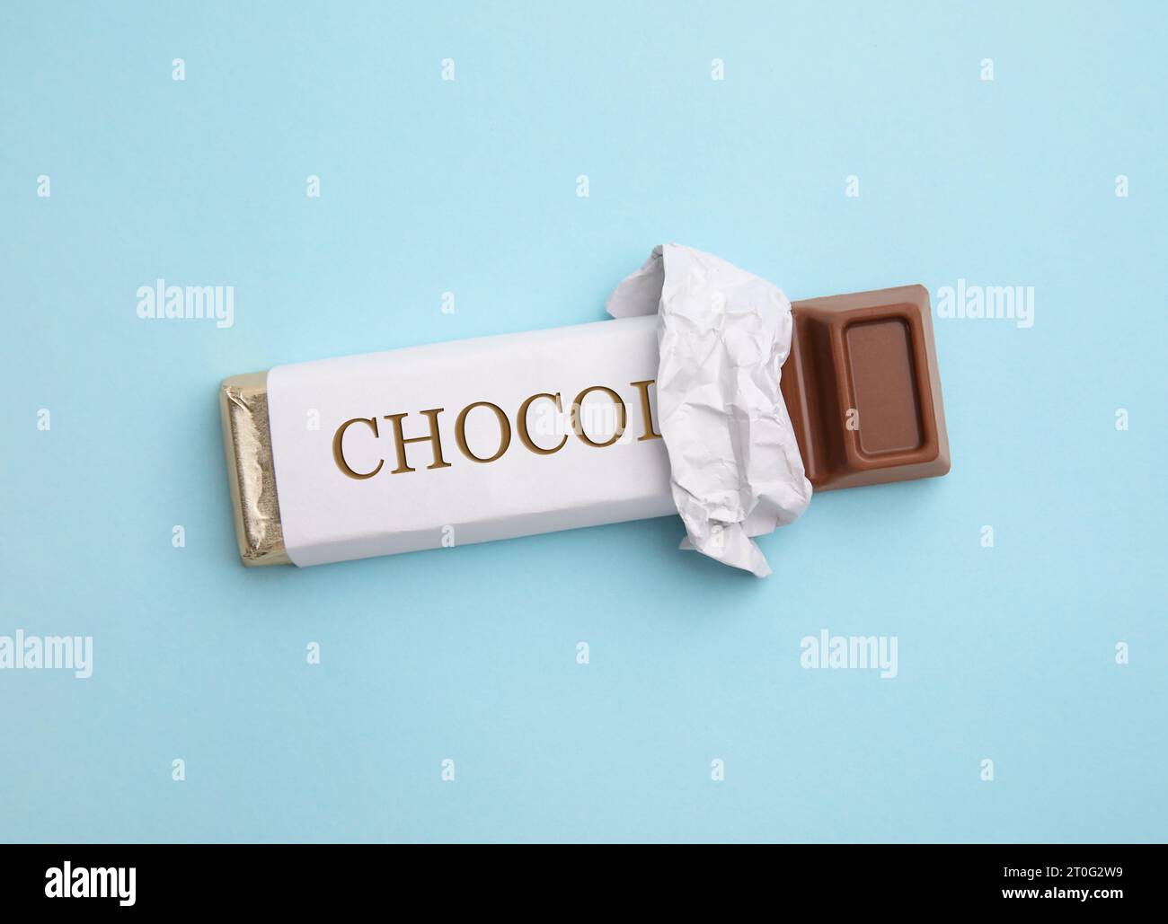 One chocolate bar in packaging on light blue background, top view Stock ...